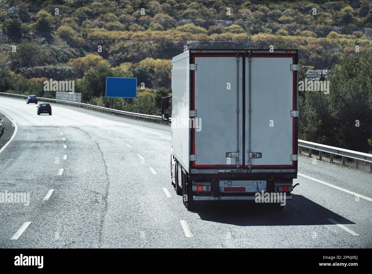 Truck on a highway - back view Stock Photo - Alamy