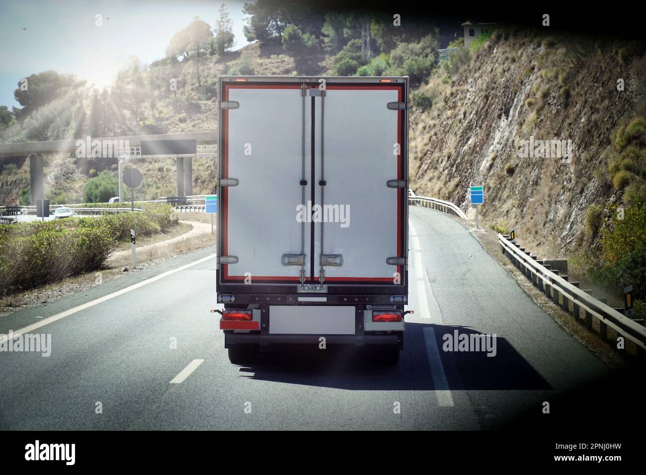 Truck on a highway - back view Stock Photo - Alamy
