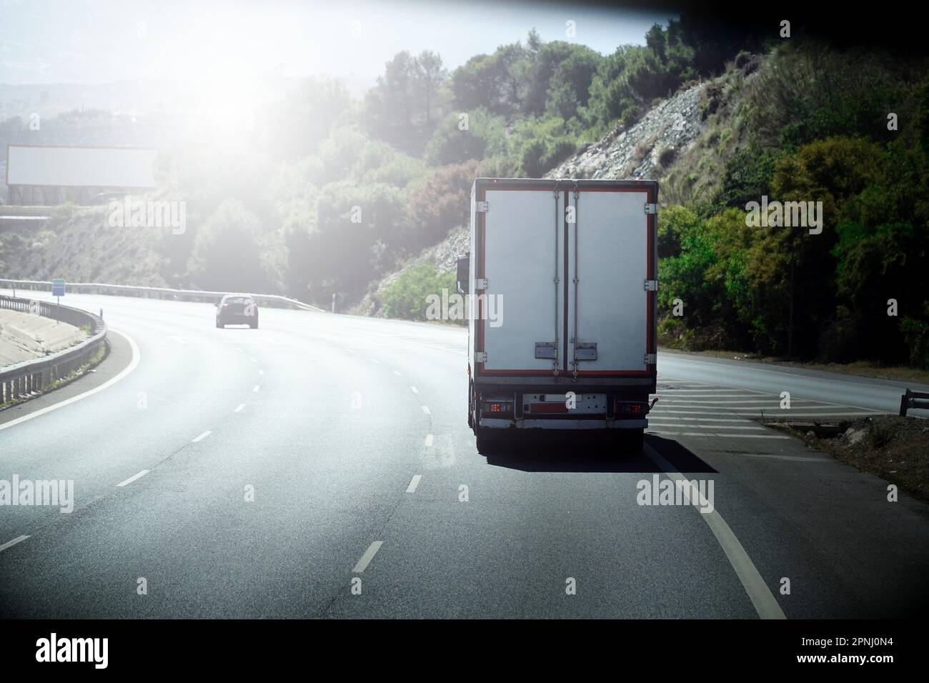 Truck on a highway - back view Stock Photo - Alamy