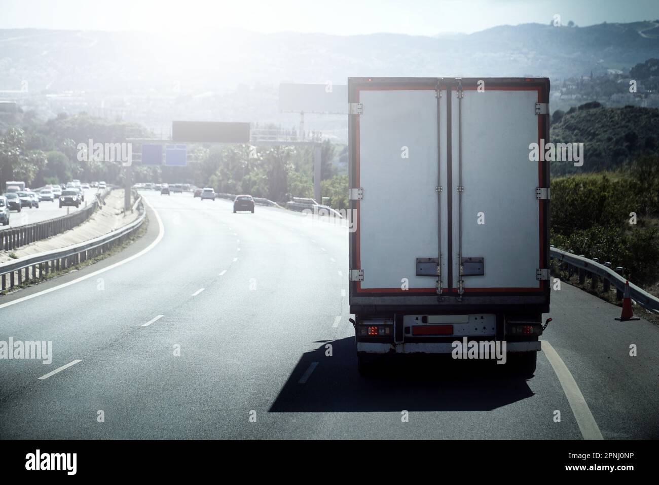 Truck on a highway - back view Stock Photo - Alamy