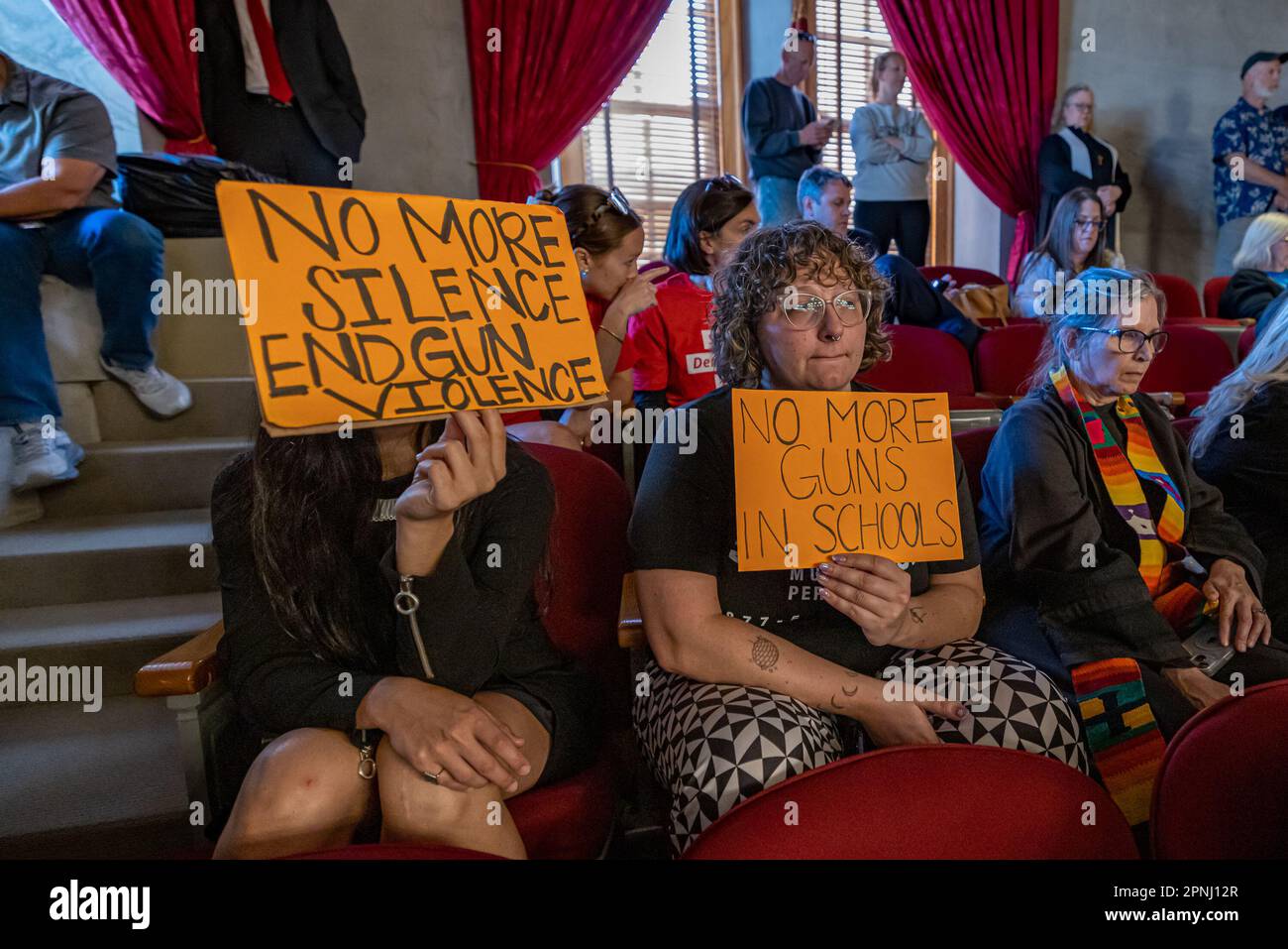 Gun control advocates hold signs inside the Tennessee Capitol chamber ...