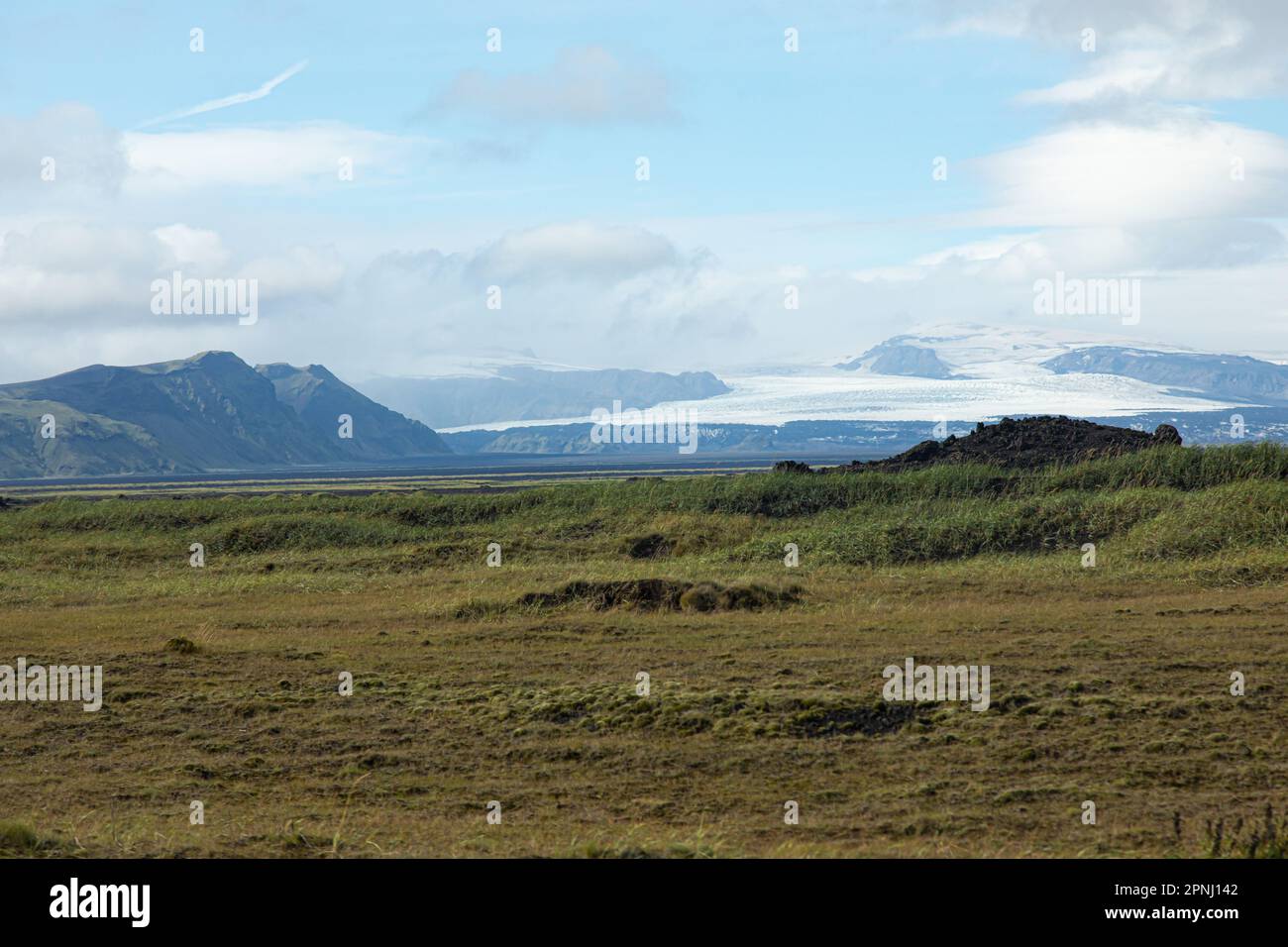 Icelandic countryside landscape with snowy mountains and Vatnajokull glacier on the background ...