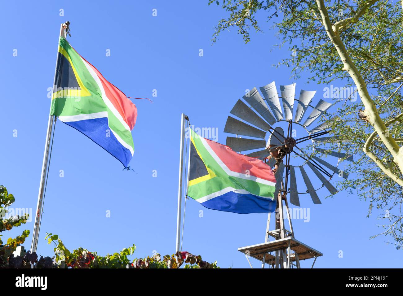 South African national flags in front of a windmill at Barrydale on ...