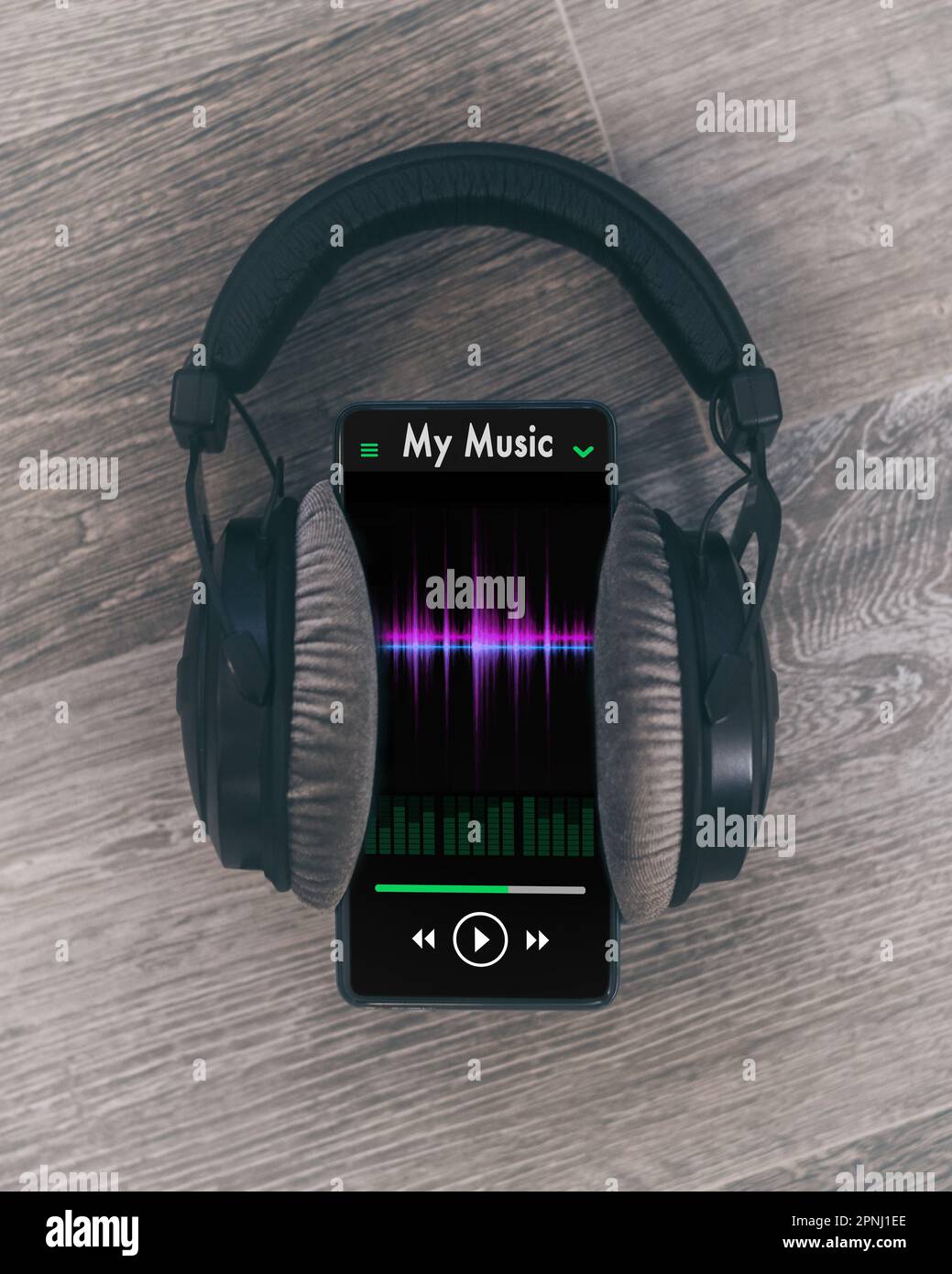 Smartphone playing music with headphones. Wooden background. Radio ...
