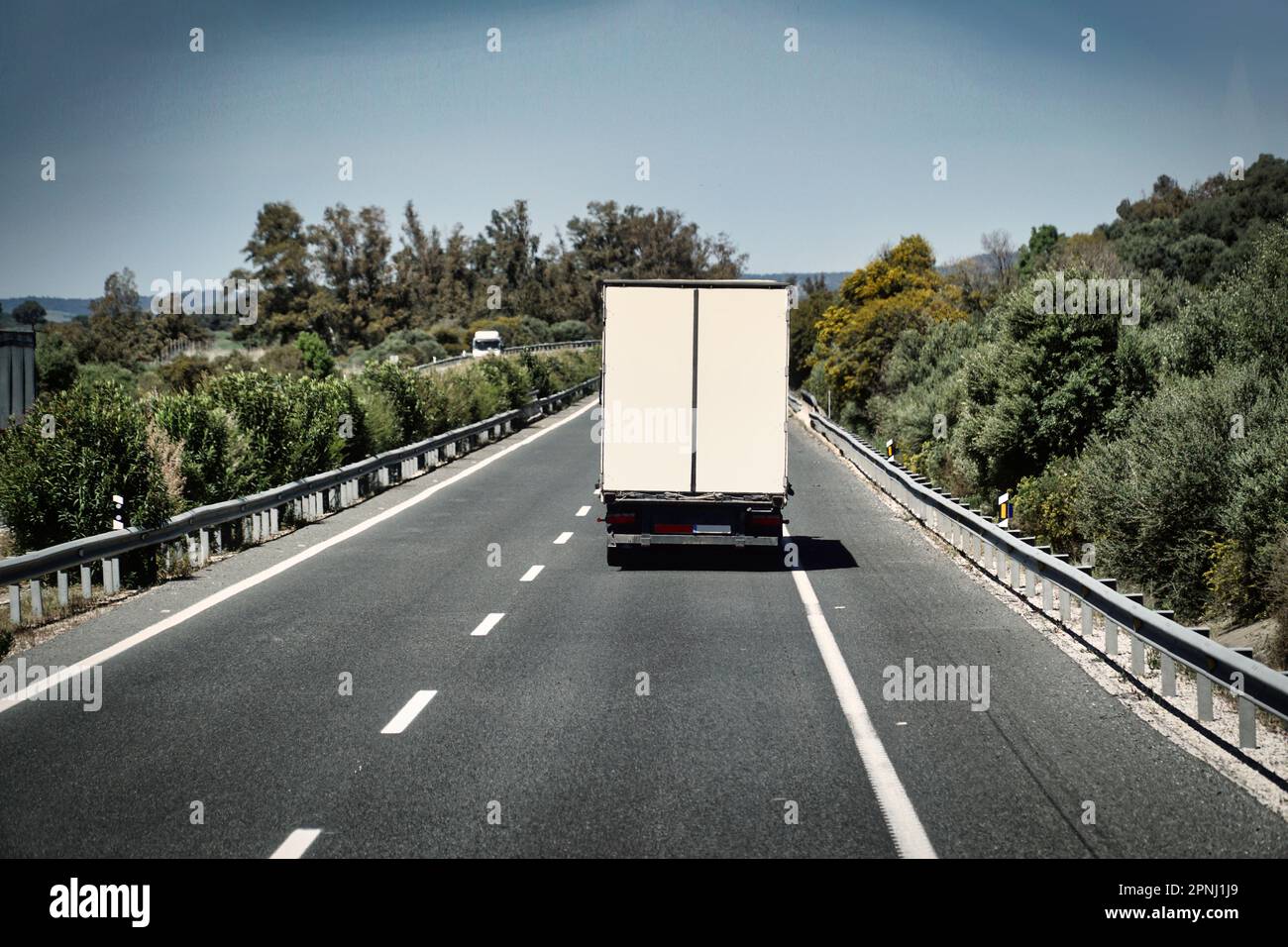 Truck on a highway - back view Stock Photo - Alamy