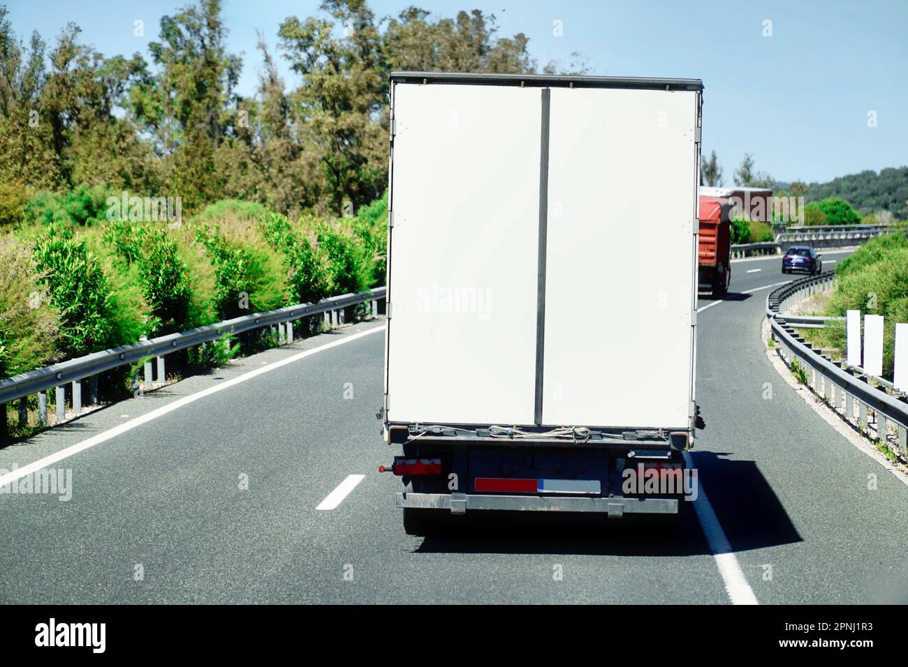 Truck on a highway - back view Stock Photo - Alamy