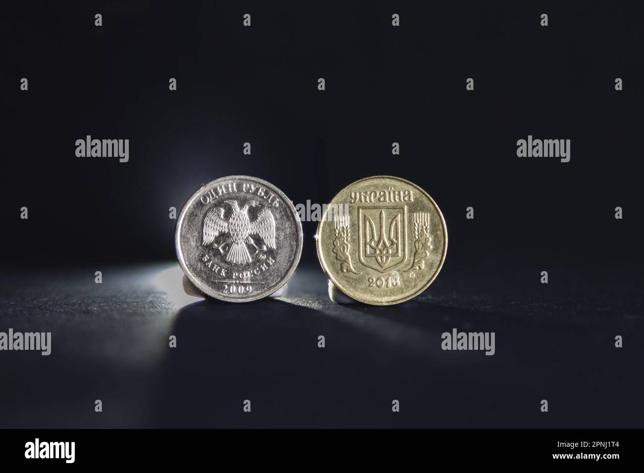 Two coins next to each other, a russian coin of one ruble, and a ...