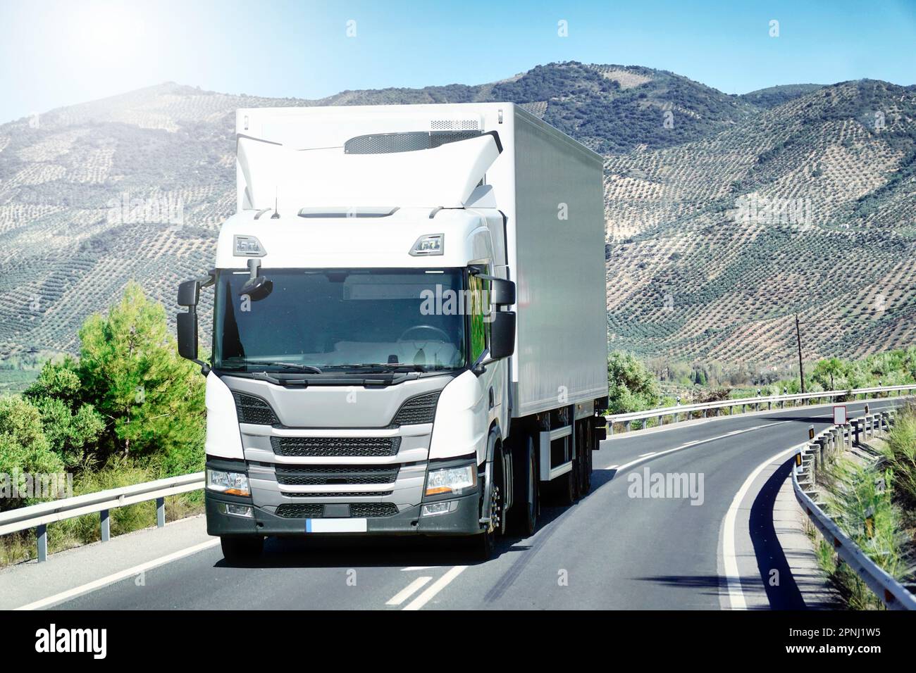 Truck on a road - front view, mountains on second plan Stock Photo - Alamy