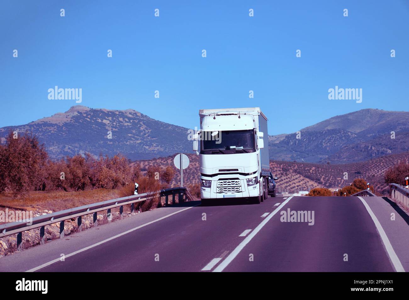 Truck on a road - front view, mountains on second plan Stock Photo - Alamy