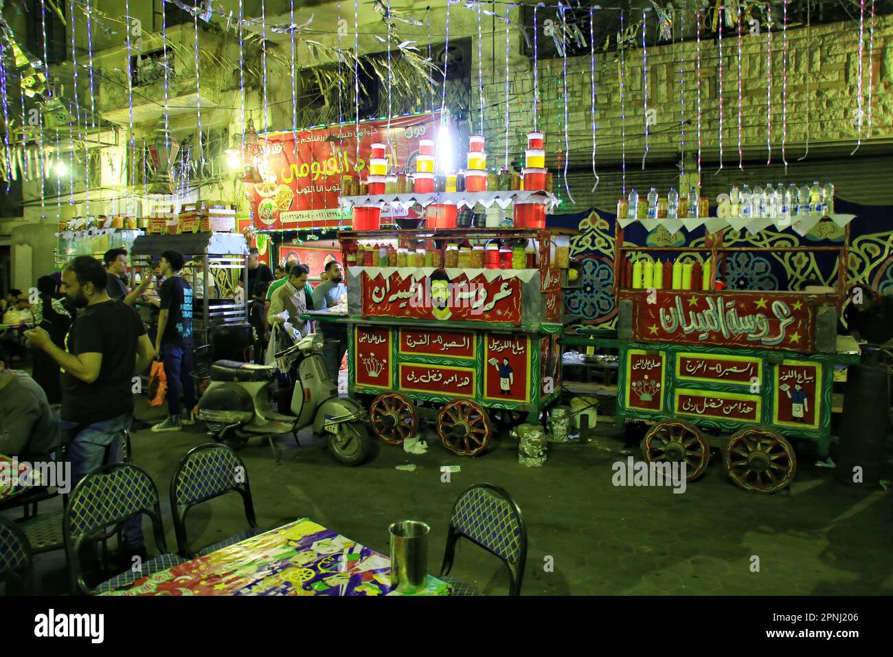 People sit in a street restaurant to eat the traditional Egyptian food ...