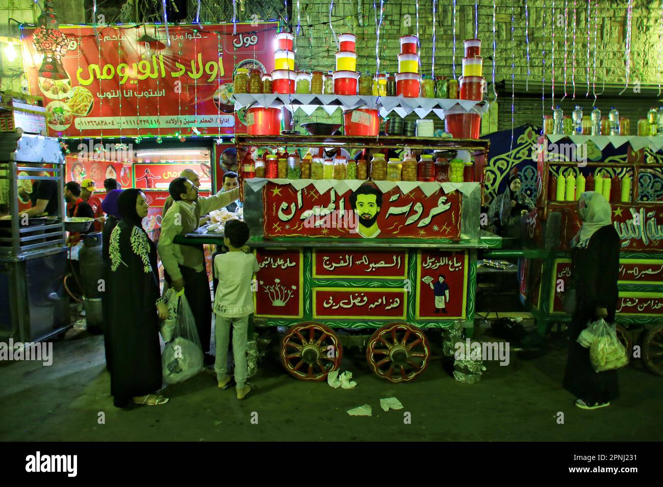 People sit in a street restaurant to eat the traditional Egyptian food ...