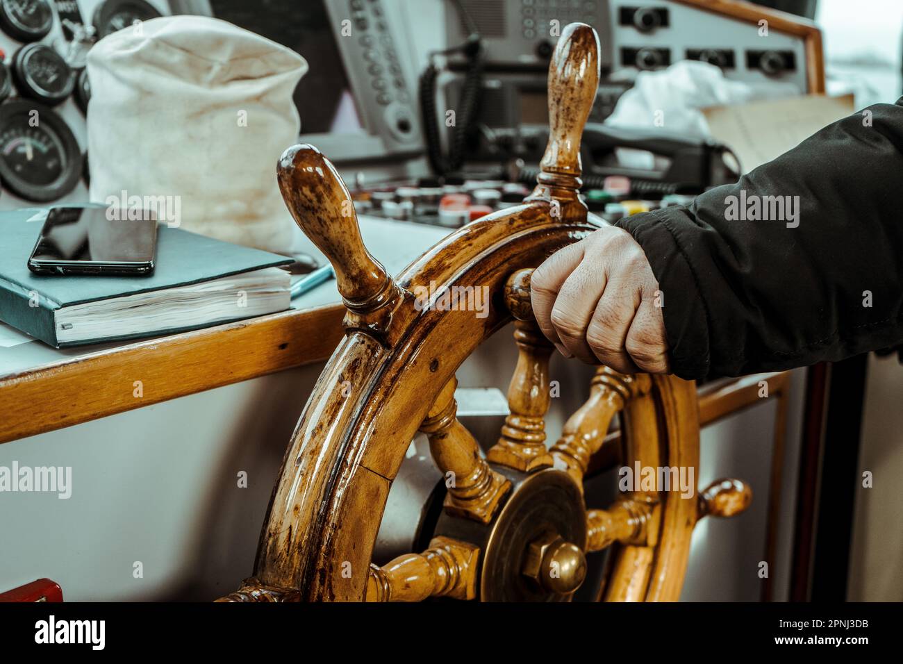captain steers boat by a wooden vintage steering wheel Stock Photo - Alamy