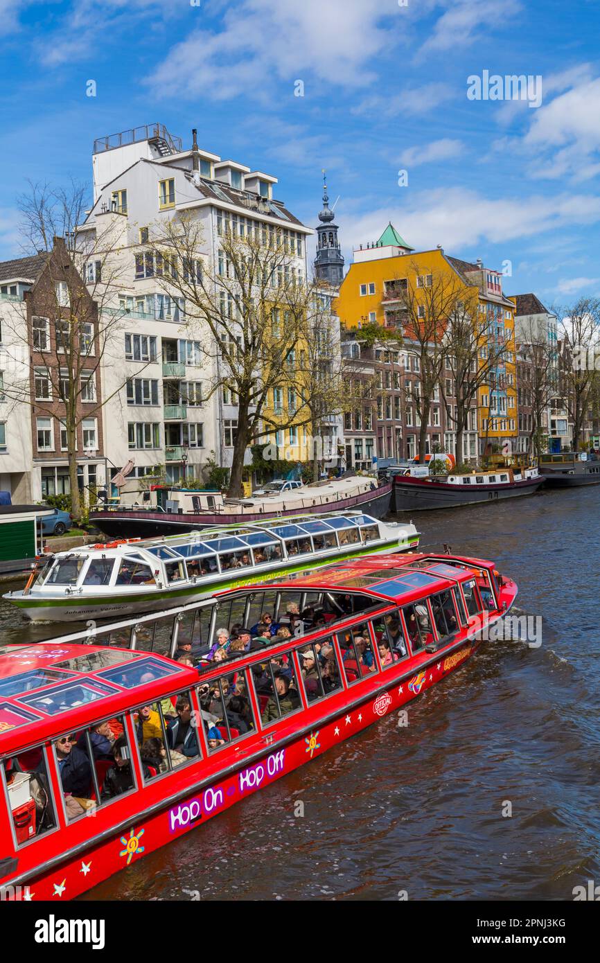 Tourists on City Sightseeing Amsterdam hop on hop off tour boat ...