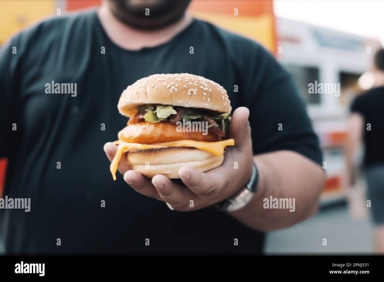 Man holds burgers in his hand against the background of a food truck ...