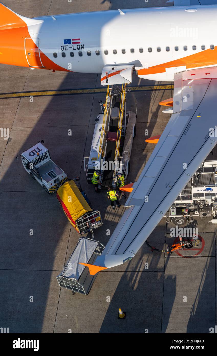 Plane being refueled and luggage loaded at airport, Easyjet plane being ...