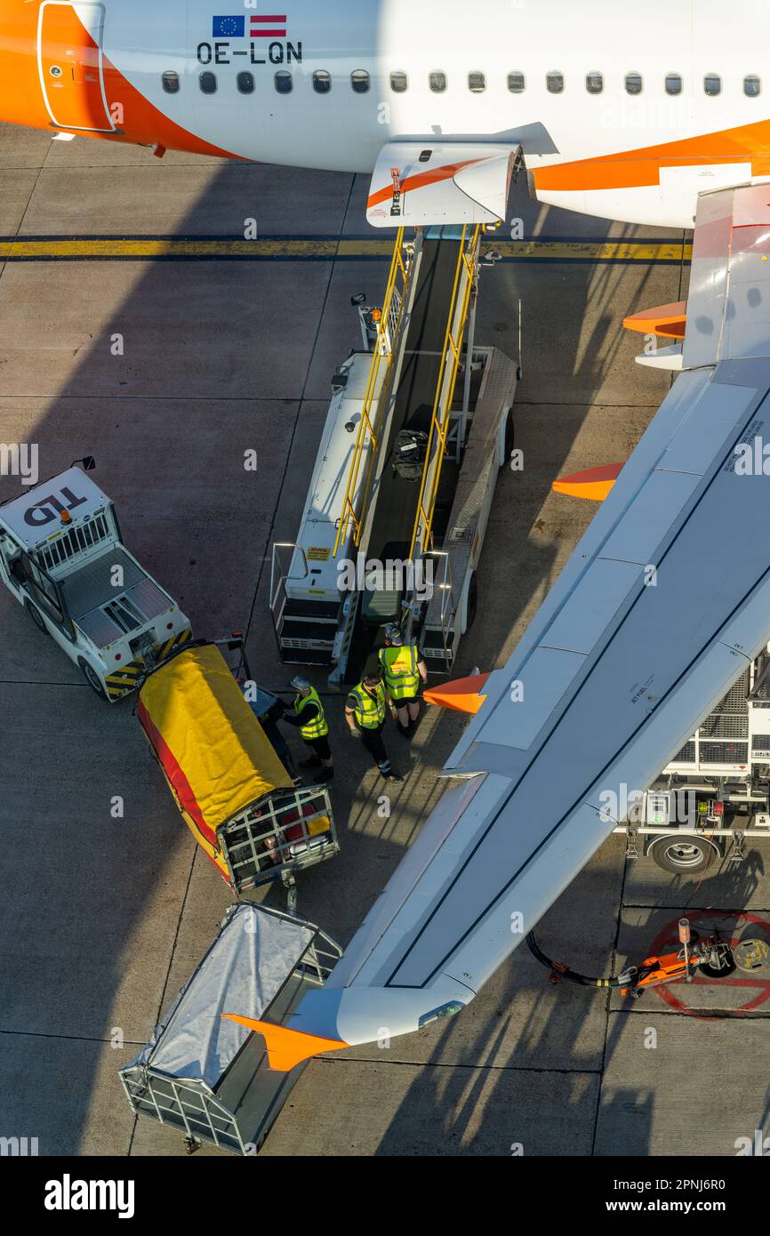Plane being refueled and luggage loaded at airport, Easyjet plane being ...