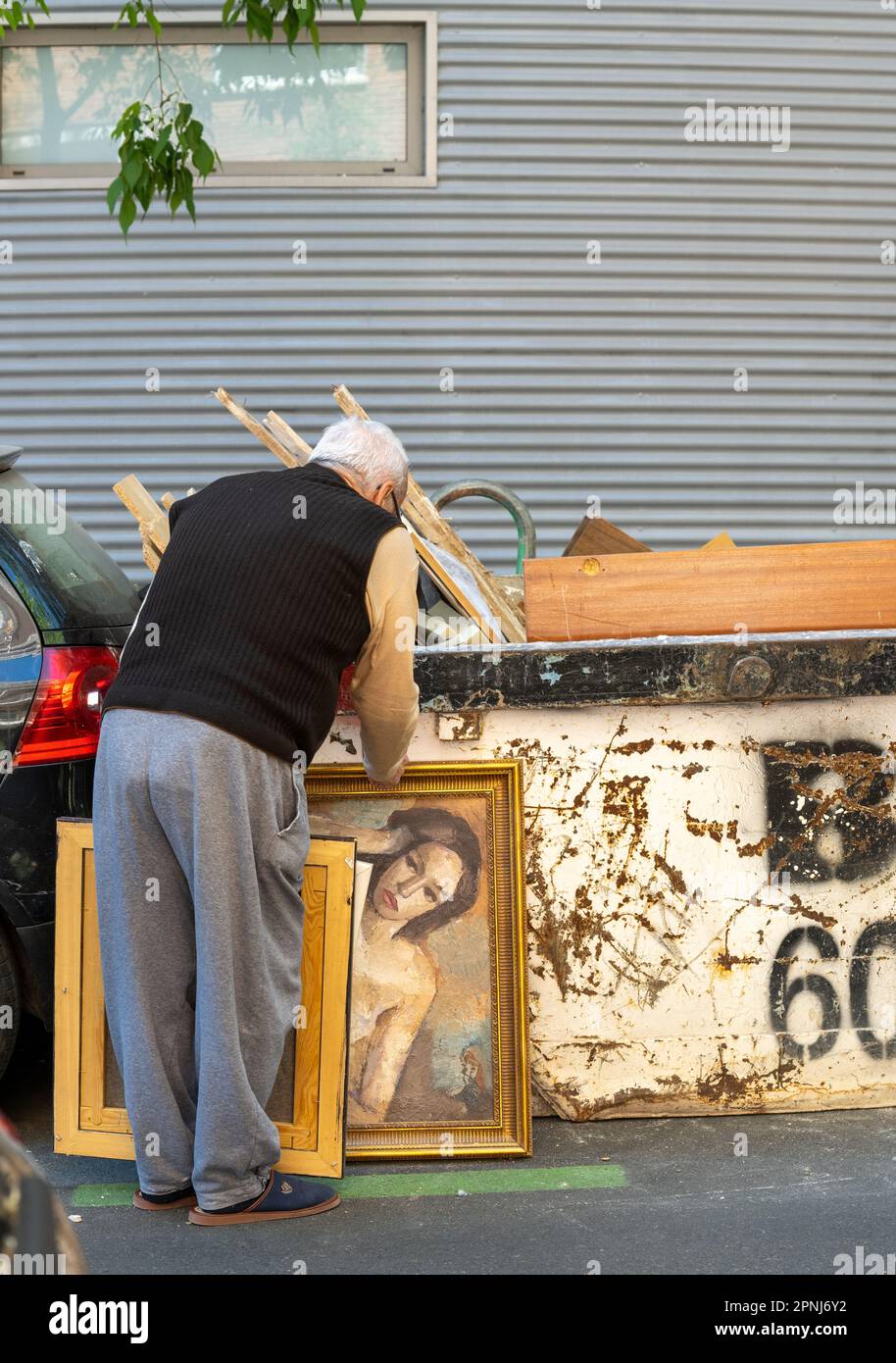 man taking paining, art work, from skip Stock Photo - Alamy