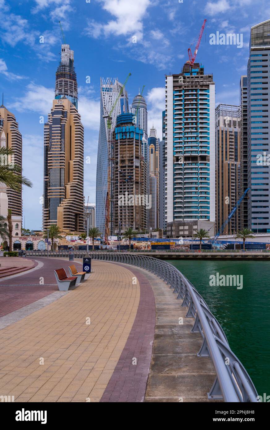 Dubai, UAE - April 2, 2023: Tall apartment blocks surround the water at ...