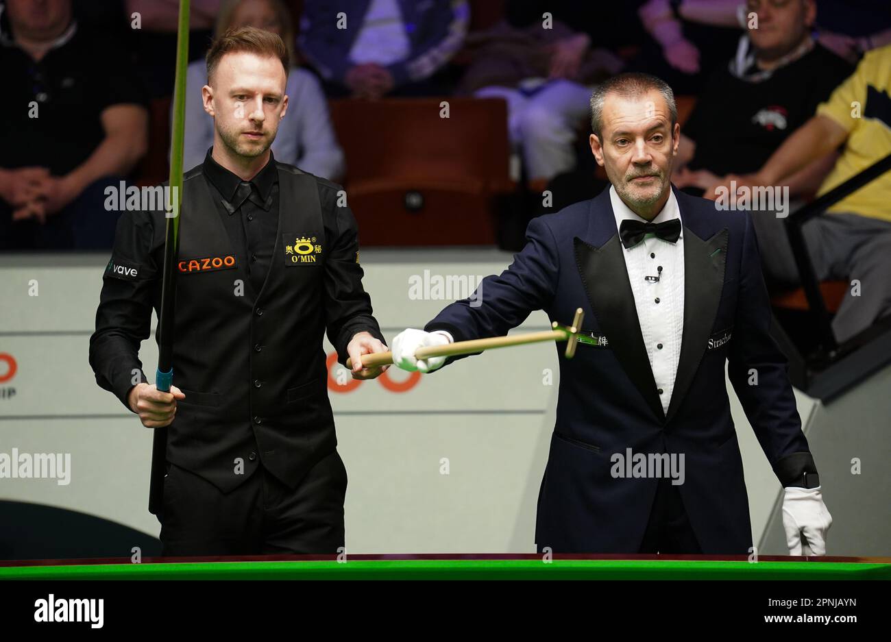 Judd Trump hands the rest to referee Olivier Marteel during his match ...