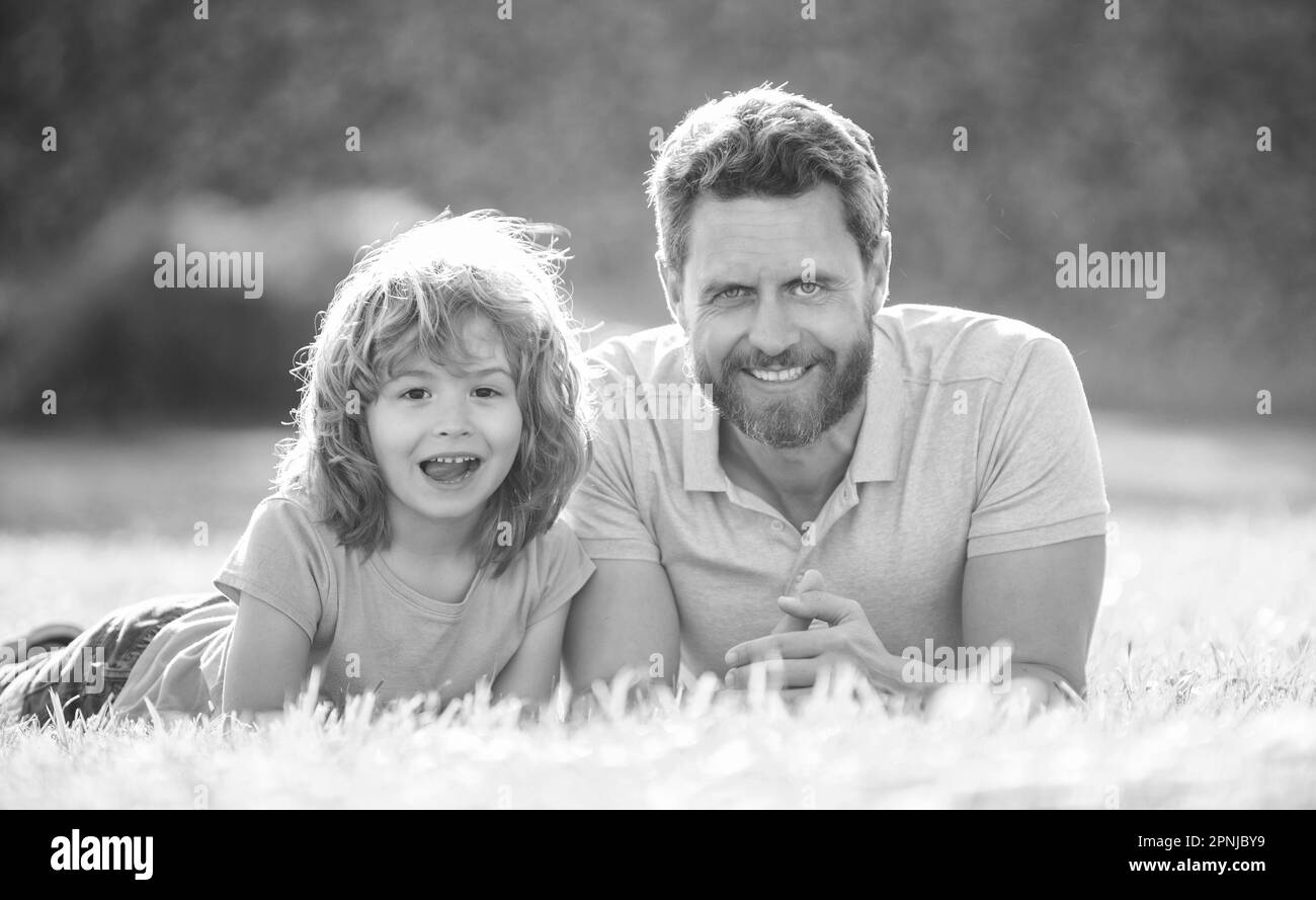 happy family of father and son kid relax in summer park green grass ...