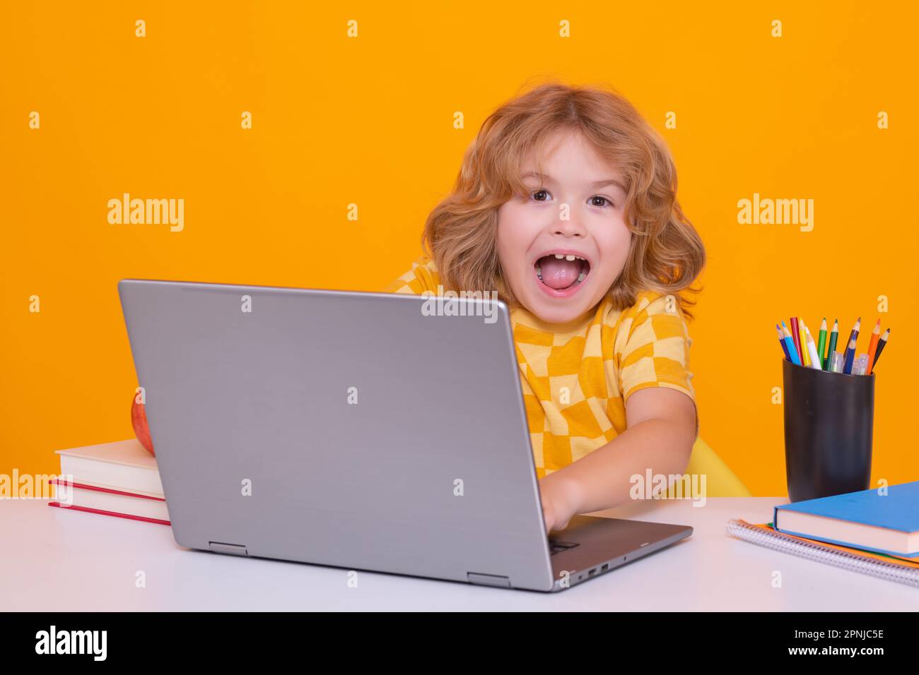 Excited pupil. Excited school child using laptop computer. Back to ...