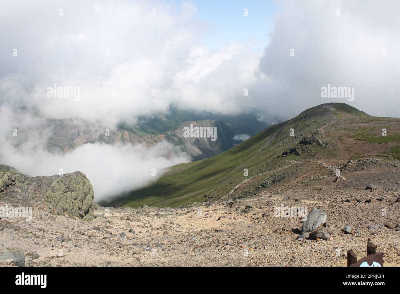 A mountainous landscape with white clouds floating over peaks Stock ...