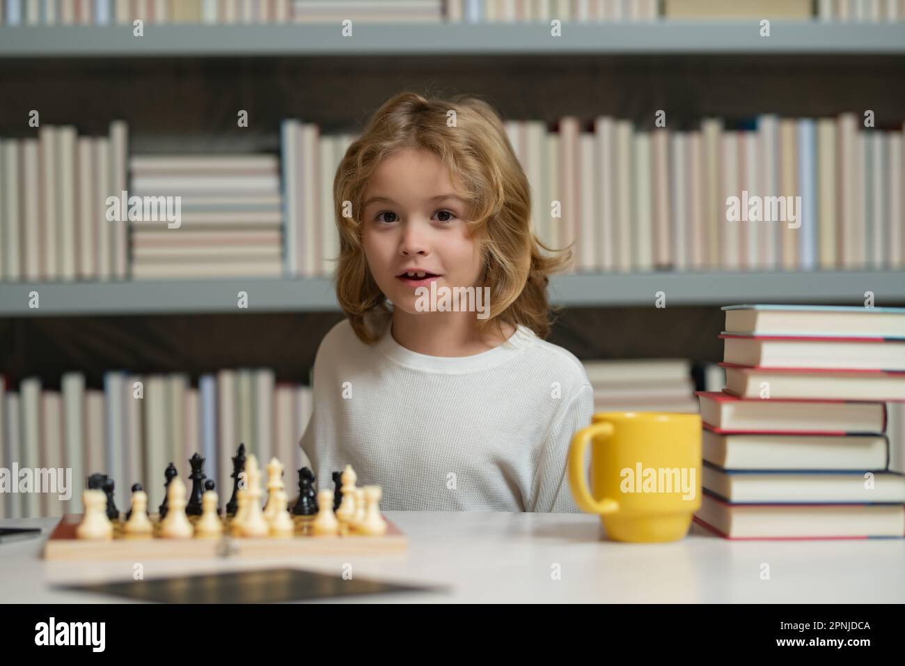 Child boy developing chess strategy, playing board game. Intelligent ...