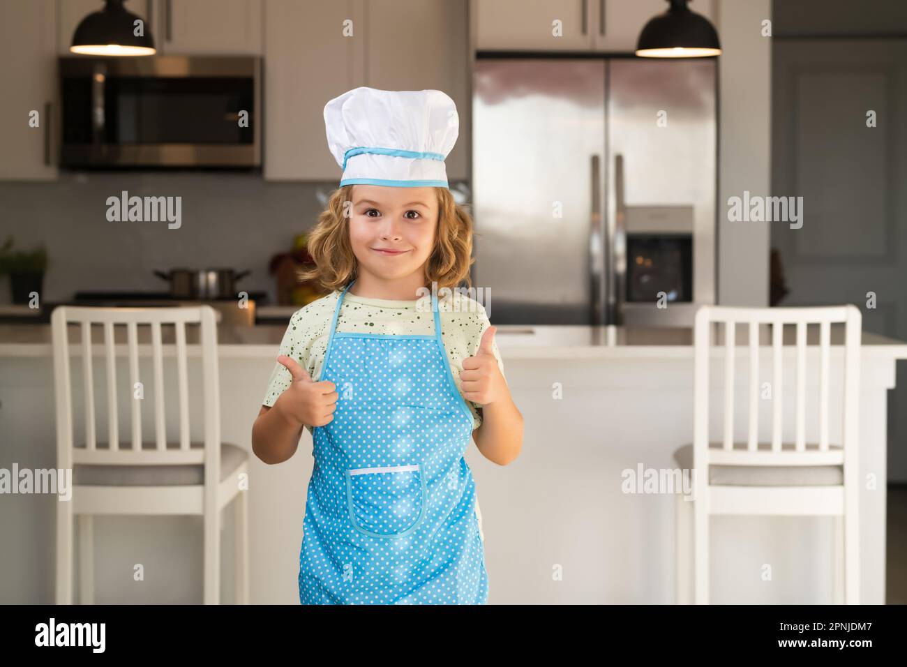 Funny little kid chef cook wearing uniform cook cap and apron cooked ...