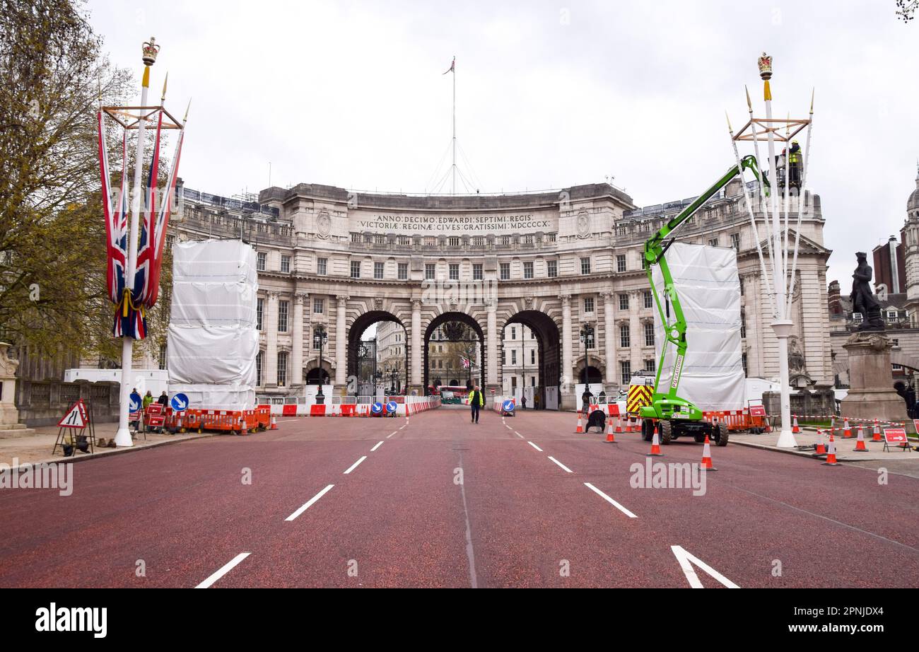 London, UK. 19th April 2023. Workers install decorative crowns and ...