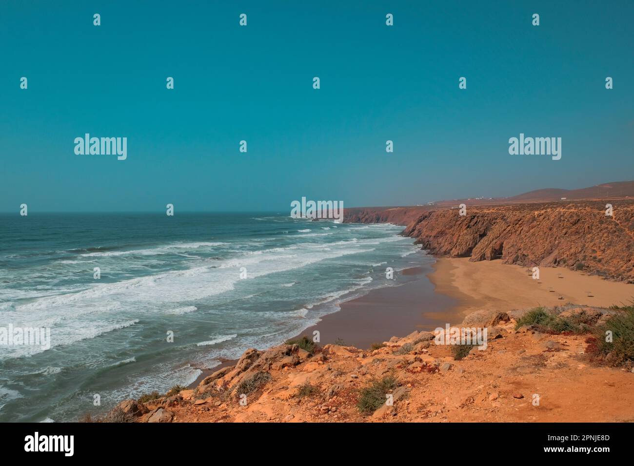 Rugged cliffside view of Aftas Beach and Atlantic Ocean in the coastal ...