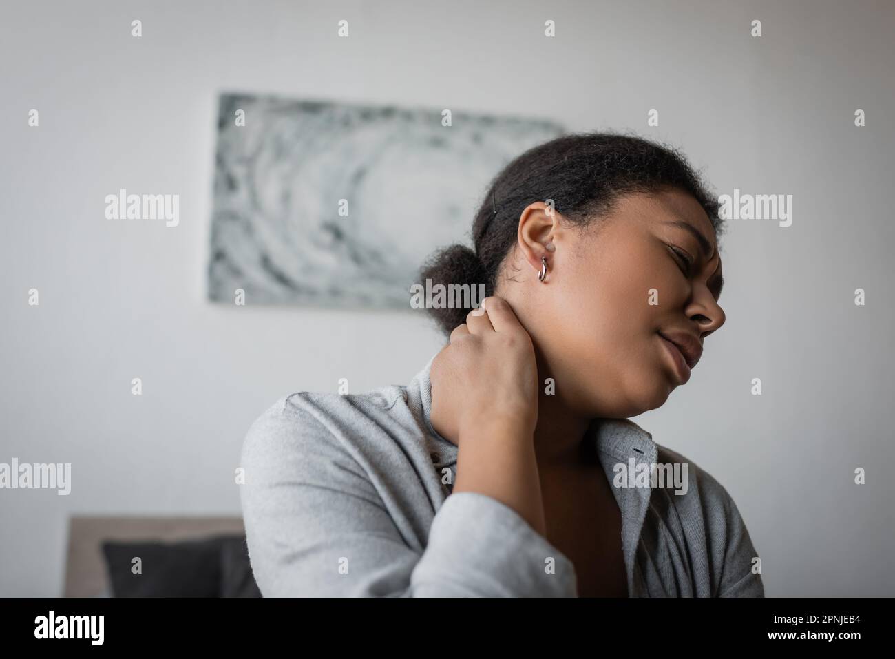 Woman touching painful neck hi-res stock photography and images - Alamy