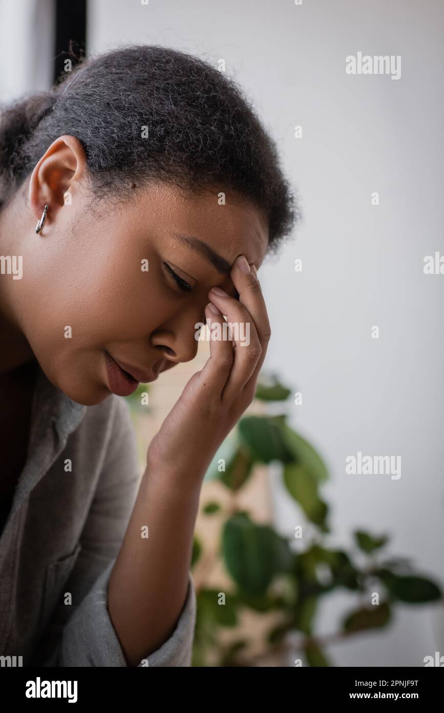 Depressed multiracial woman touching hi-res stock photography and ...