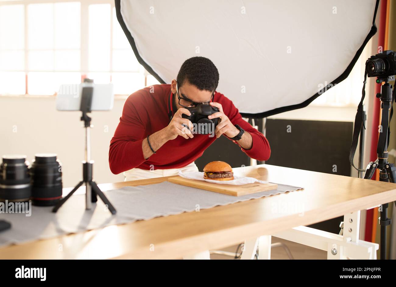 Famous photographer streaming while working on food shoot Stock Photo ...