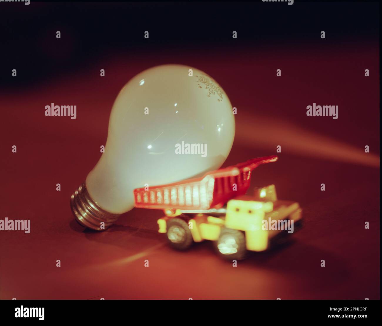 Light bulb leaning on toy dump truck Stock Photo - Alamy