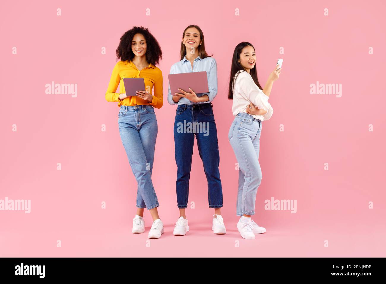 Three diverse ladies using different gadgets, networking online ...