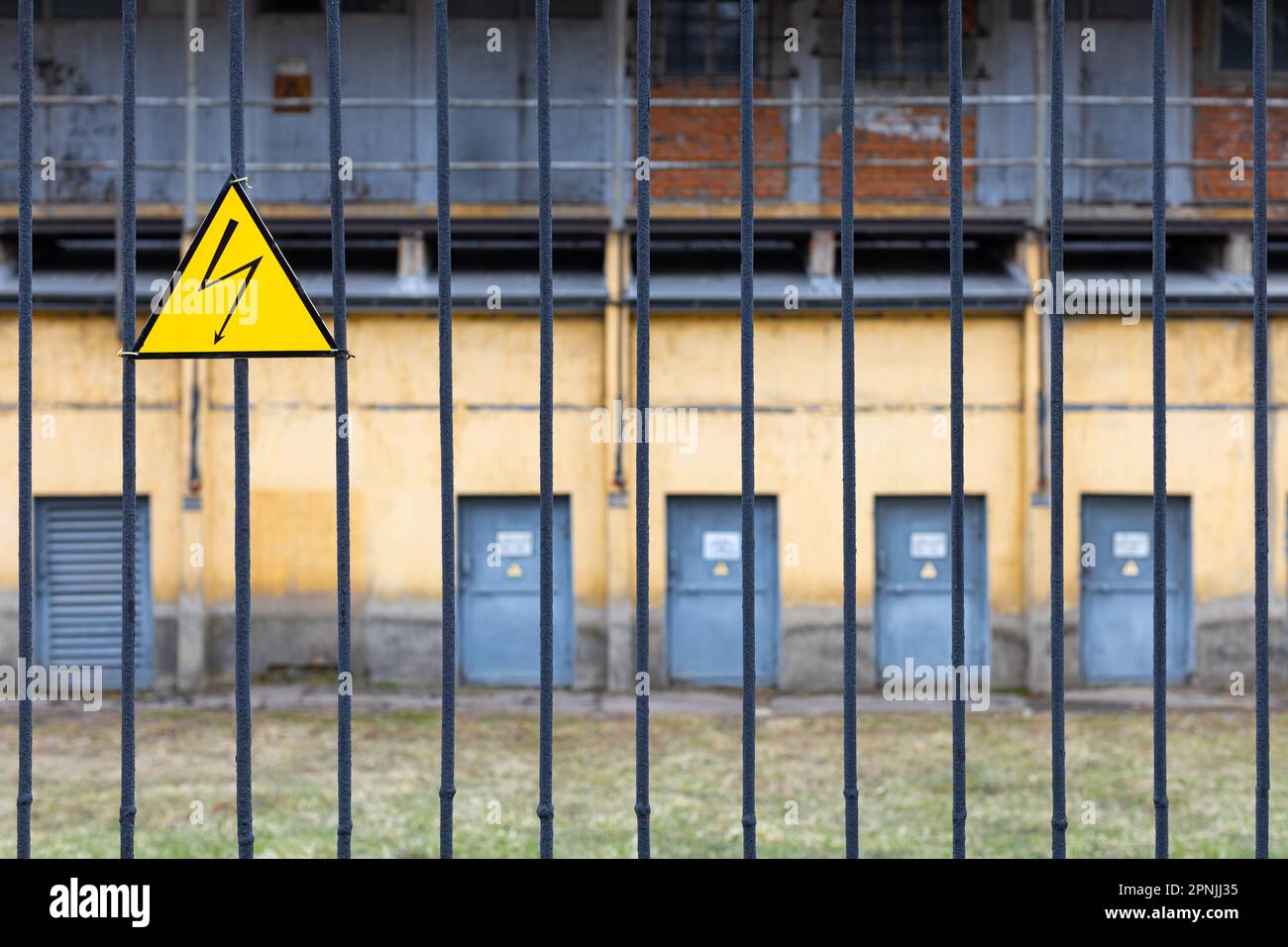 high voltage sign on the fence of a power plant. power station area ...