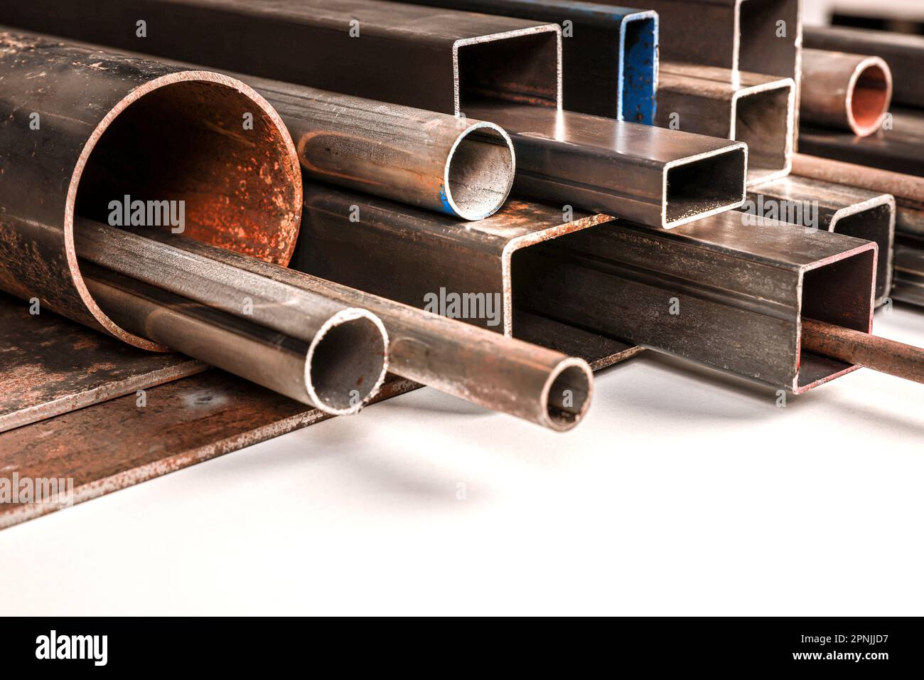 metal pipes of various shapes and sizes on a white background Stock ...
