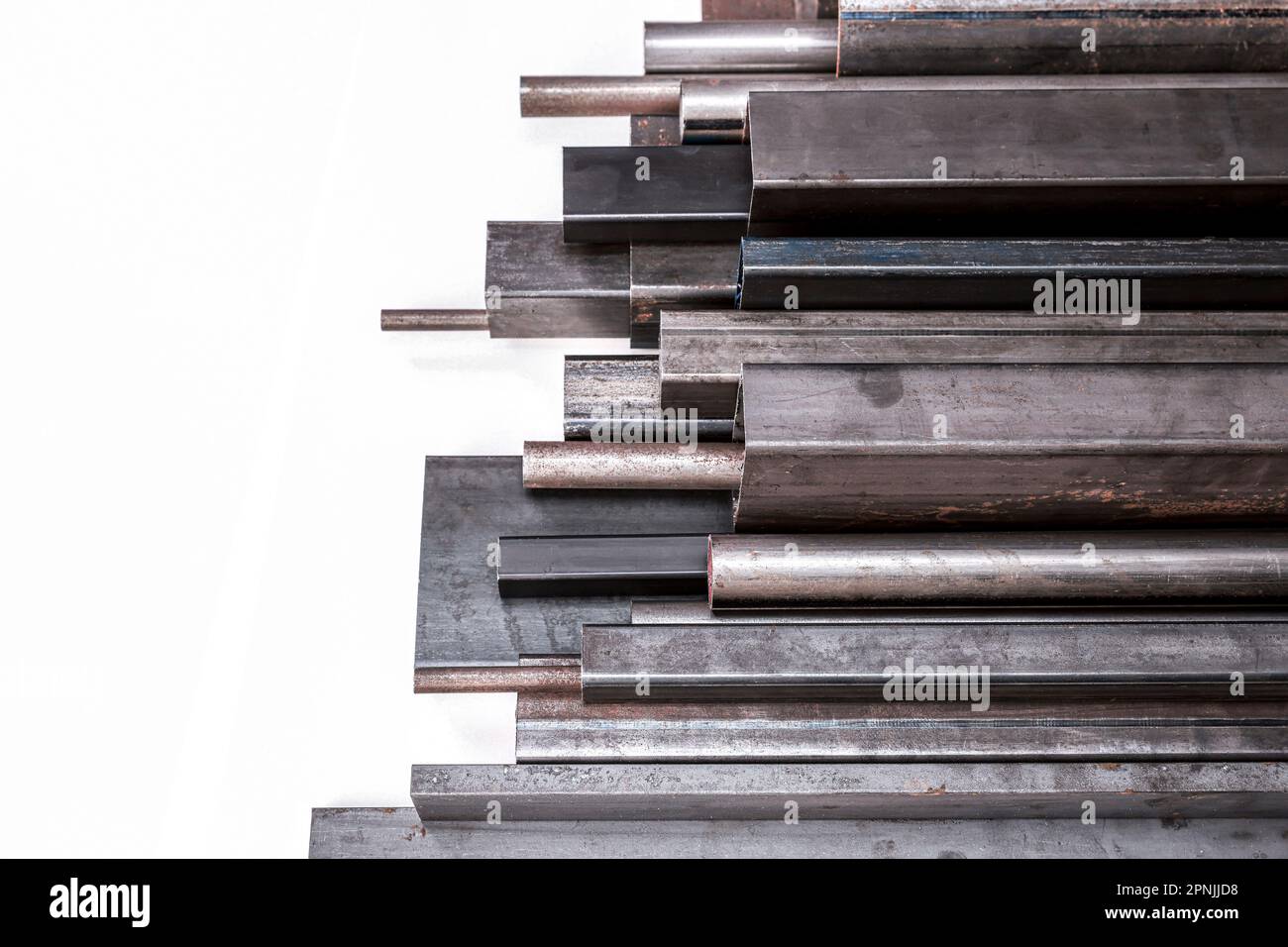 metal pipes of various shapes on a white background Stock Photo - Alamy