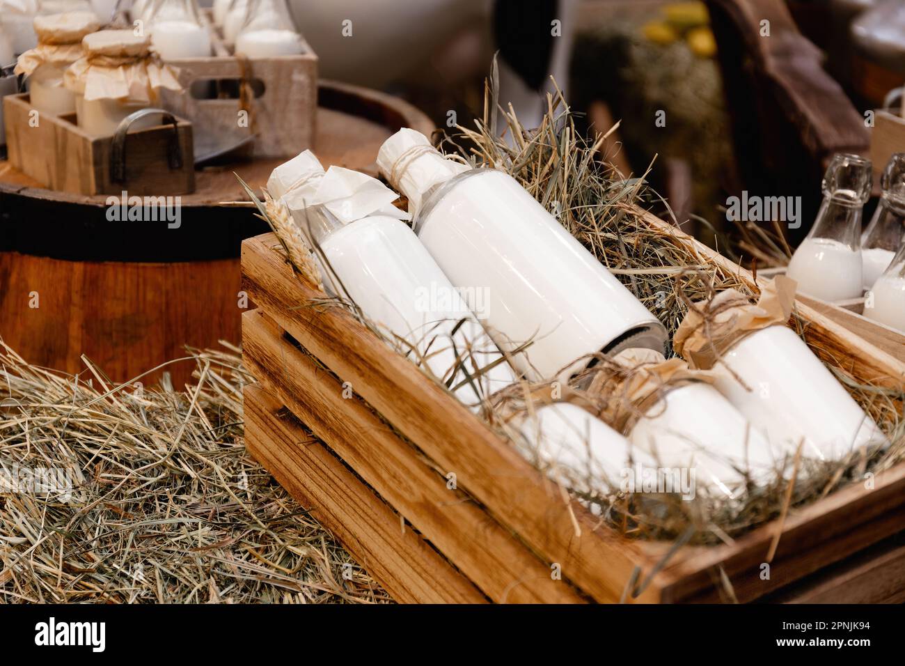 Glass bottles with fresh natural milk, aluminum cans on hay on dairy ...