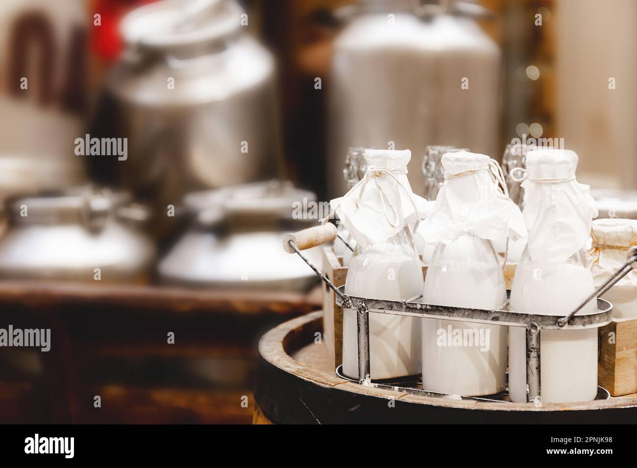 Glass bottles with fresh natural milk, aluminum cans on hay on dairy ...