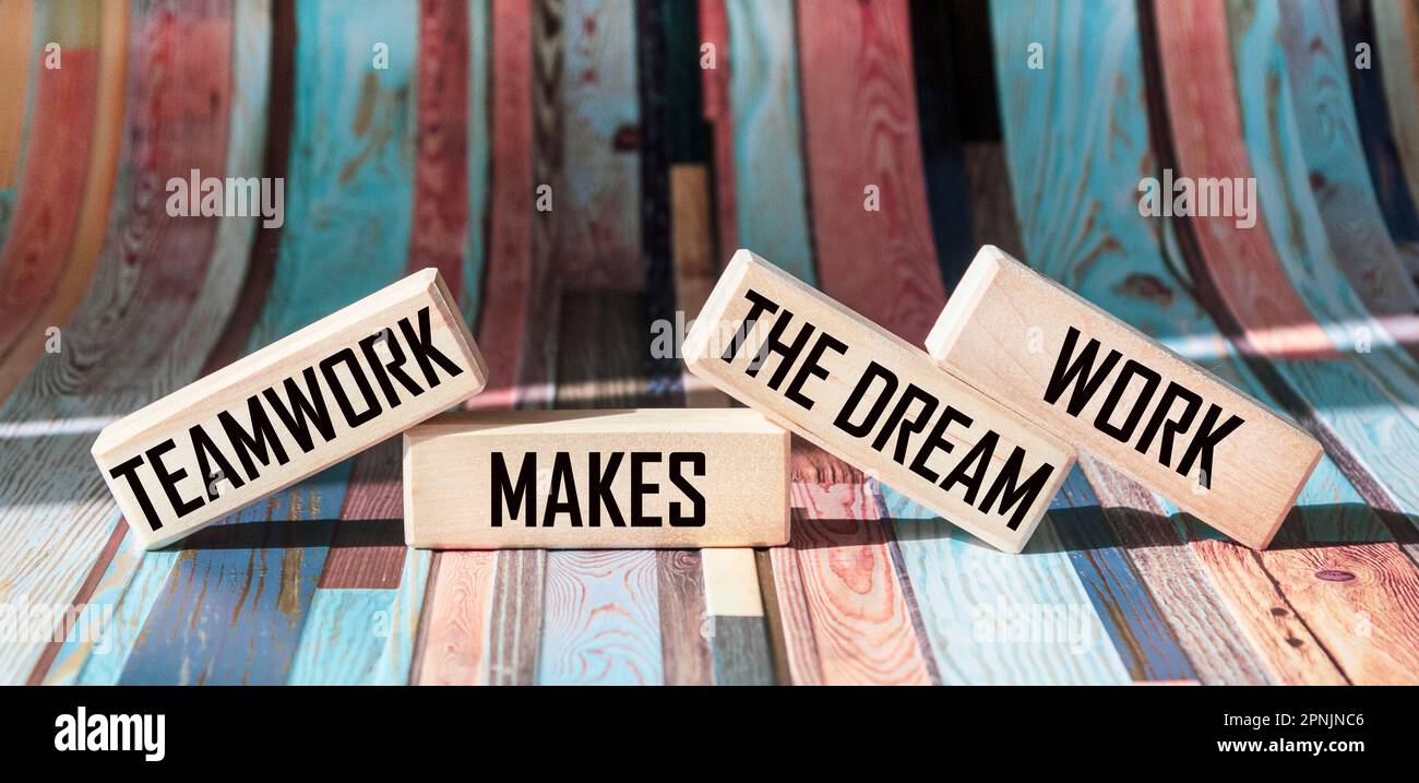 Concept words TMDW Teamwork make a dream job on a wooden block on a ...