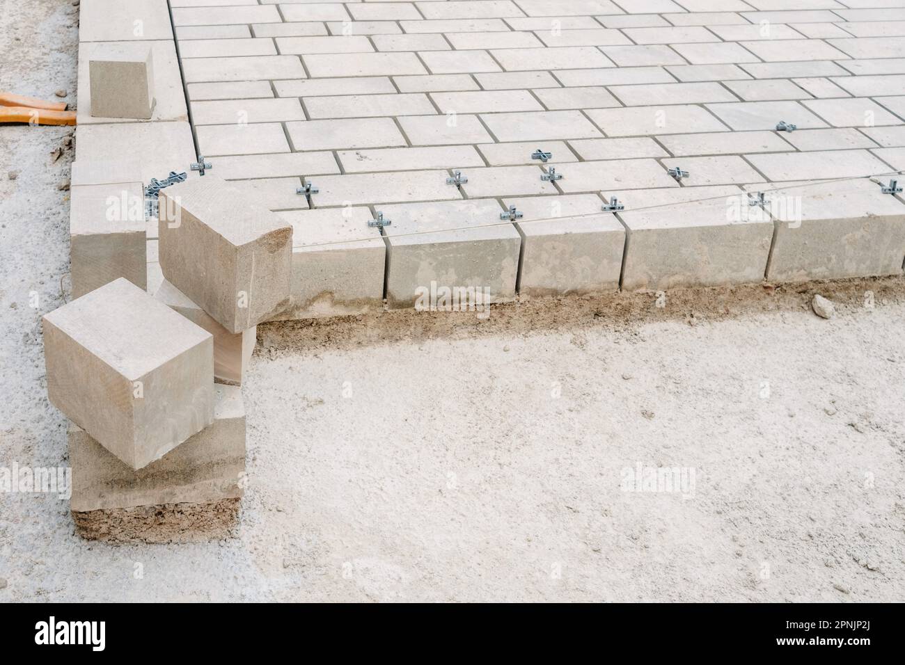 Paving a street with stone pavers, construction work in progress Stock ...