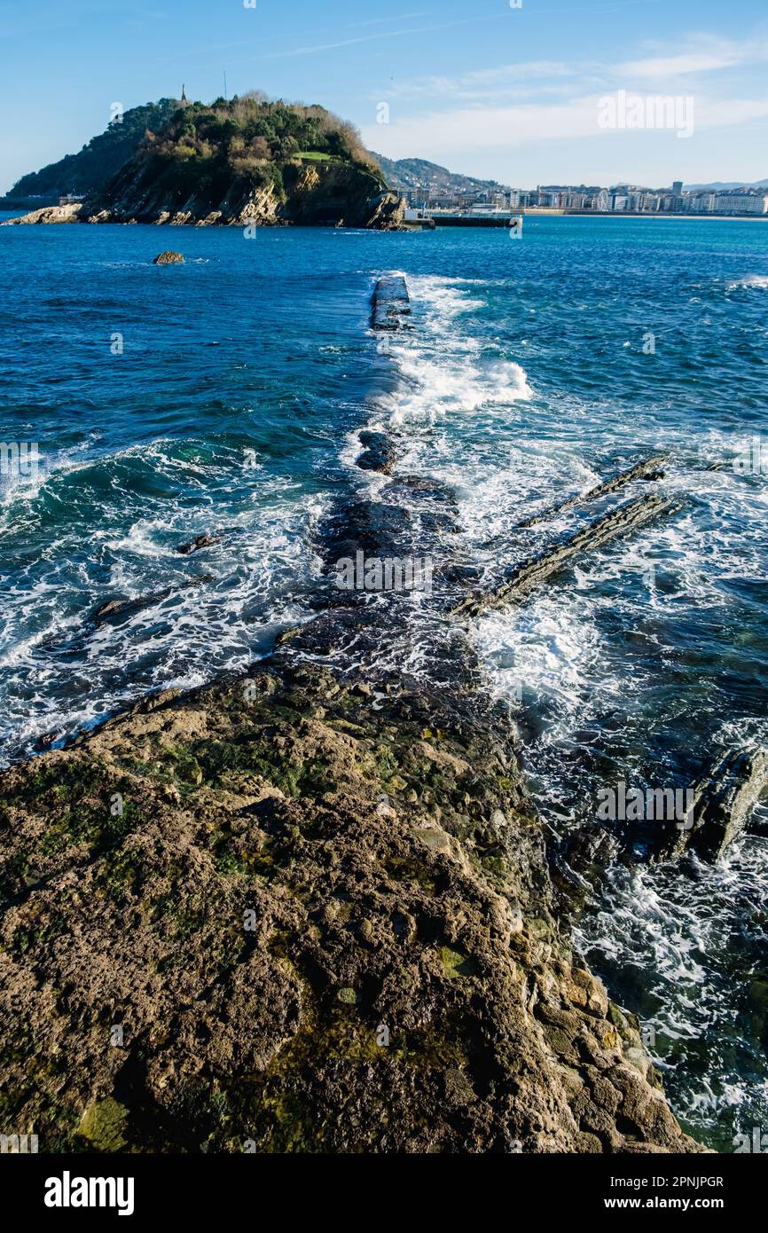 The sea beats hard on the coast and leaves visible geological ...