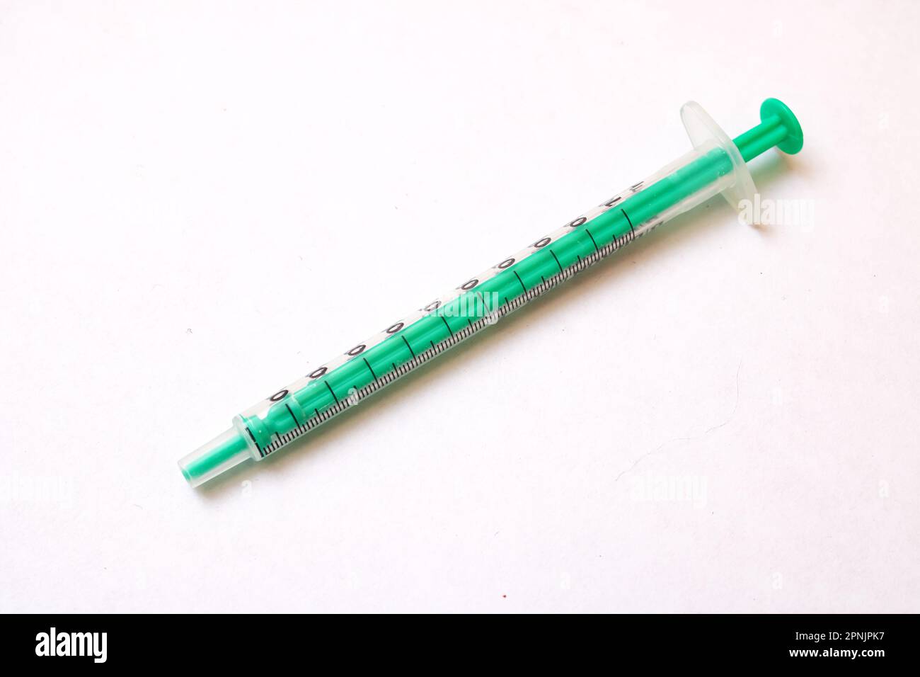 Large medical syringe on a gray background close up Stock Photo - Alamy