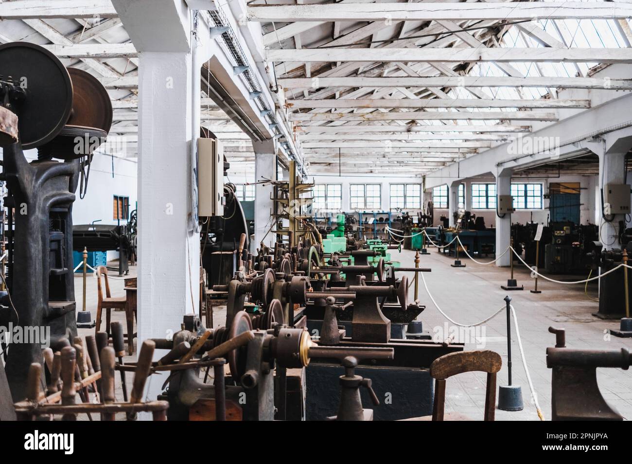 Interior of an old metalworking factory with metal lathes and presses ...