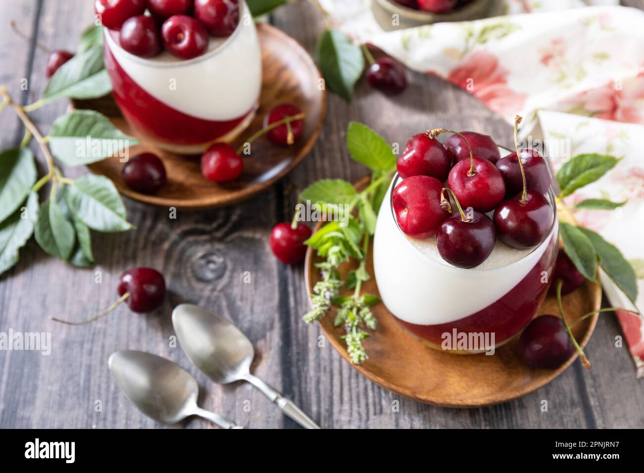 Panna cotta with sweet cherry jelly on a rustic table. Italian dessert ...