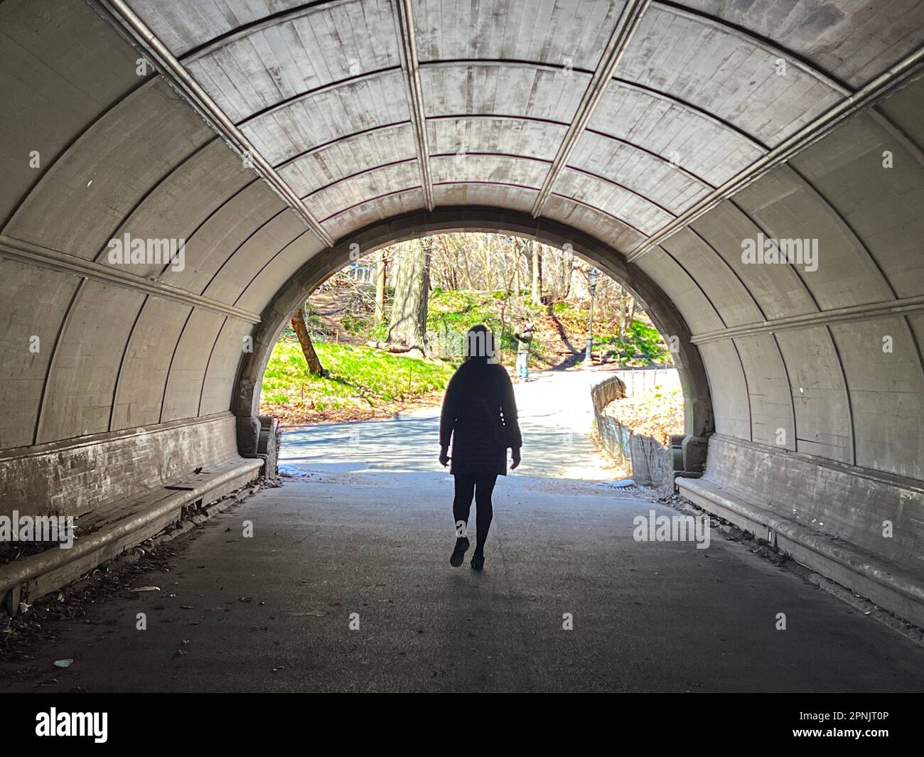Woman walking through tunnel rear view hi-res stock photography and ...