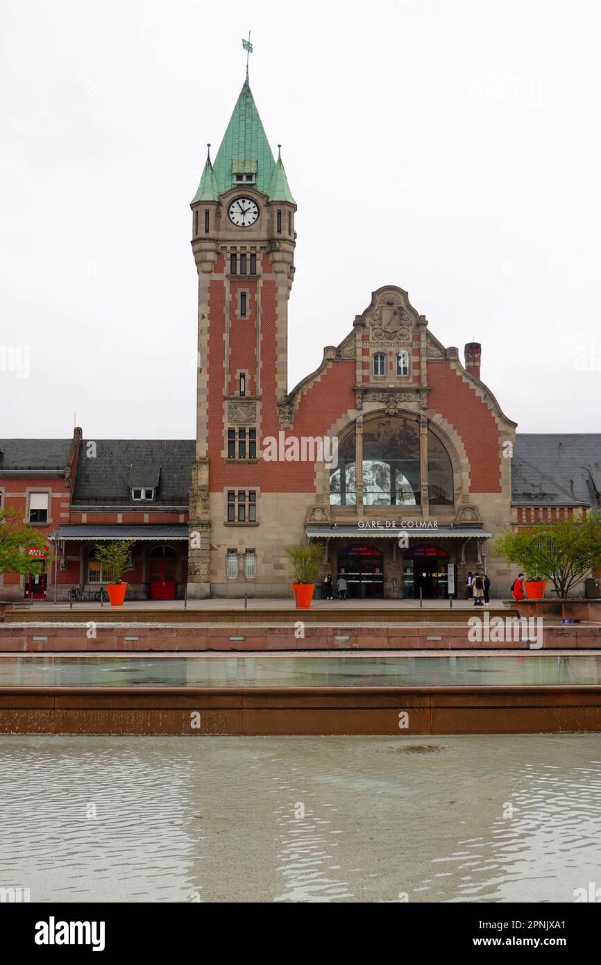 People outside the Colmar train station, and clock tower, in the Alsace ...