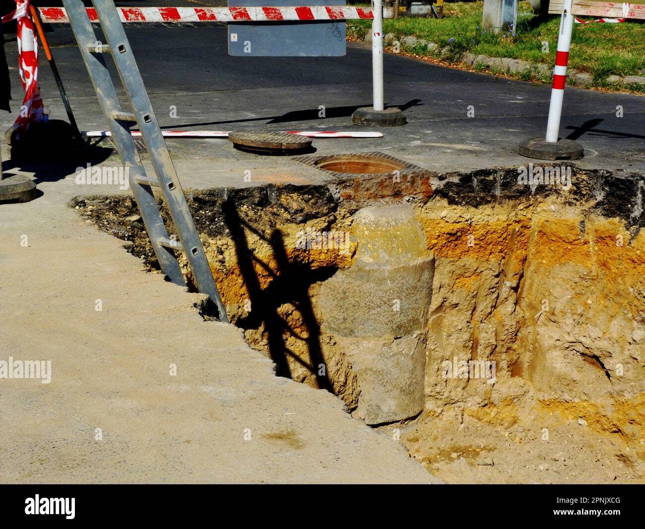 road repair and construction. work. excavated pit. manhole and service ...