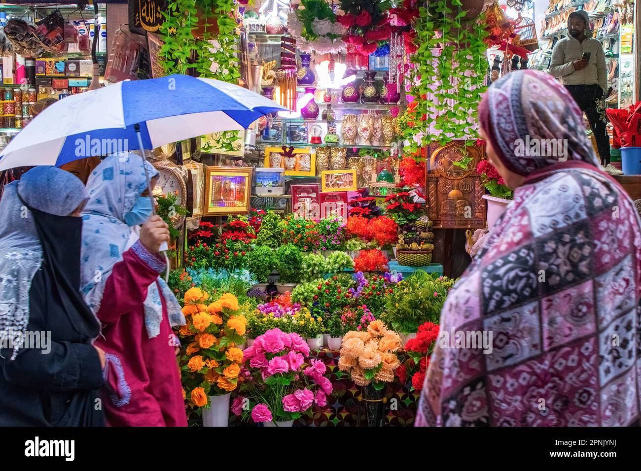 Kashmiri people seen shopping during rainfall ahead of the Muslim festival Eid-al-Fitr at a ...
